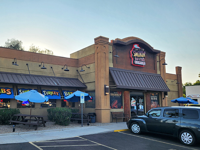 Dusk settles over Can't Stop Smokin' BBQ, transforming this unassuming strip mall spot into a beacon for the barbecue faithful.