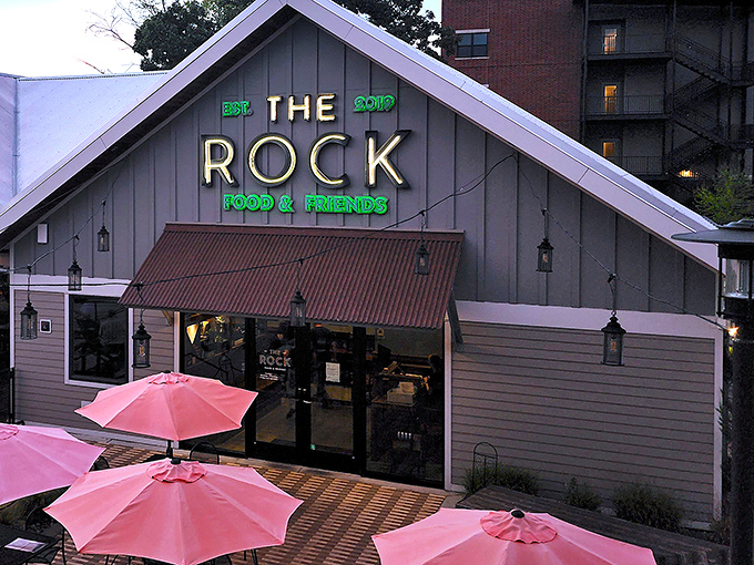 As evening falls, The Rock's illuminated sign beckons hungry travelers like a lighthouse for the gastronomically adrift.