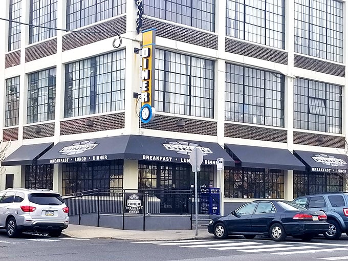 The iconic blue and yellow Fishtown Diner sign stands like a beacon of breakfast hope on this Philadelphia corner, promising comfort food salvation to hungry passersby.