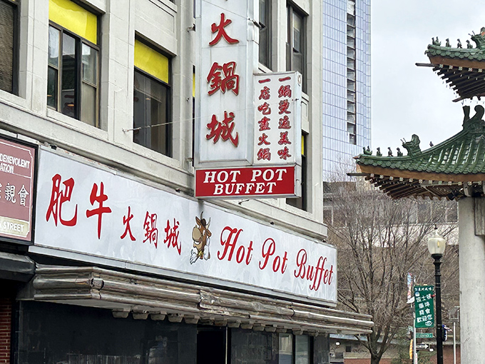 The bright red signage of Hot Pot Buffet stands as a beacon in Boston's Chinatown, promising culinary adventures that transcend language barriers.