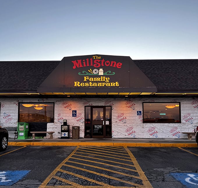 The iconic Millstone sign glows against the twilight sky, a beacon for pie enthusiasts and comfort food aficionados alike.