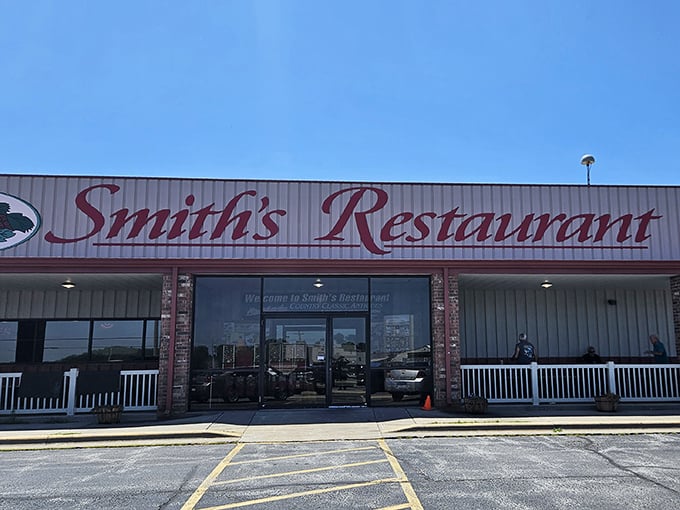 The iconic red cursive sign of Smith's Restaurant stands as a beacon of comfort food against the Missouri sky &ndash; a promise of homestyle goodness awaiting inside.