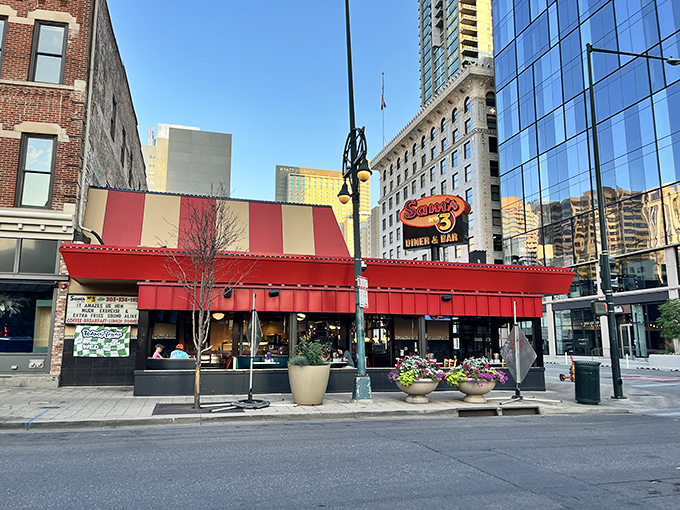The iconic red and yellow awning of Sam's No. 3 stands out in downtown Denver like a beacon of breakfast hope amid the modern high-rises.