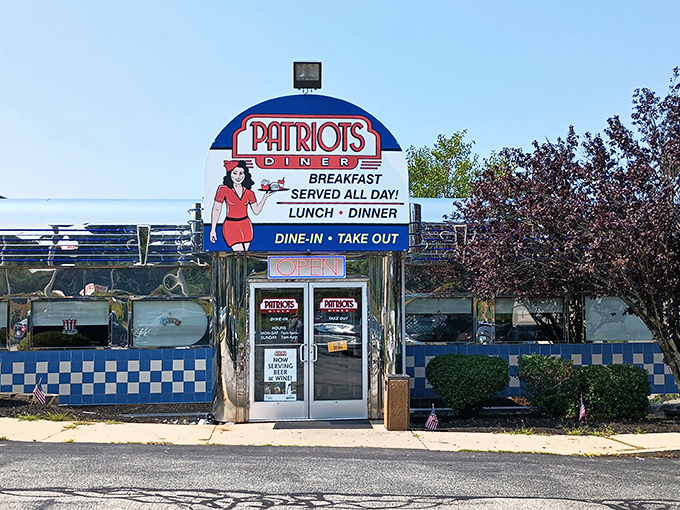 The iconic blue and white checkered exterior of Patriots Diner stands like a time machine to the golden age of American breakfast. That retro sign promises everything your morning needs.