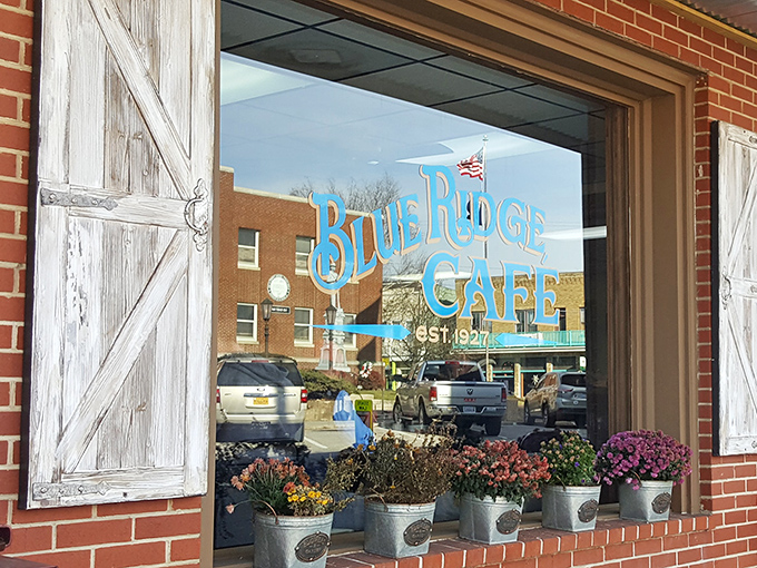 Through rustic barn-style shutters, the Blue Ridge Cafe window offers a glimpse into Floyd's culinary heart, complete with charming flower pots that say "welcome home."