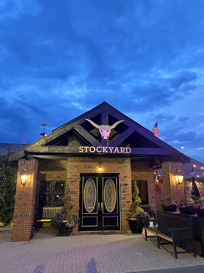 As dusk falls, the Stockyard transforms from brick-and-mortar restaurant to beacon of beefy delights under dramatic skies.