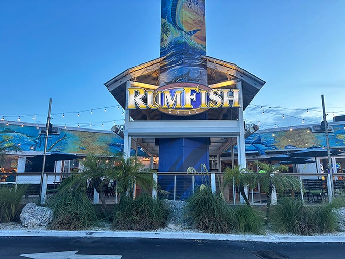 The iconic RumFish Grill exterior welcomes visitors with vibrant marine artwork and twinkling string lights &ndash; Florida dining with a splash of adventure.