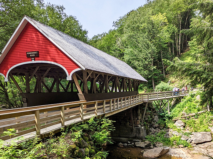 The iconic red covered bridge at Franconia Notch looks like it belongs on a postcard or, let's be honest, your next holiday card. Pure New England magic.