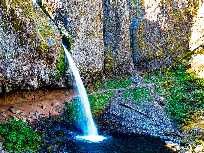 Nature's perfect brushstroke &ndash; this slender waterfall cascades down basalt cliffs like liquid silver, creating a pool that practically begs for a dip.