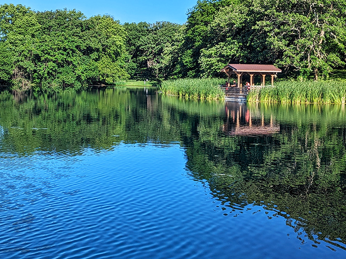 Mirror-perfect waters reflect the wooden gazebo like nature's own Instagram filter. This tranquil lake scene at Platte River State Park soothes even the most frazzled city nerves.