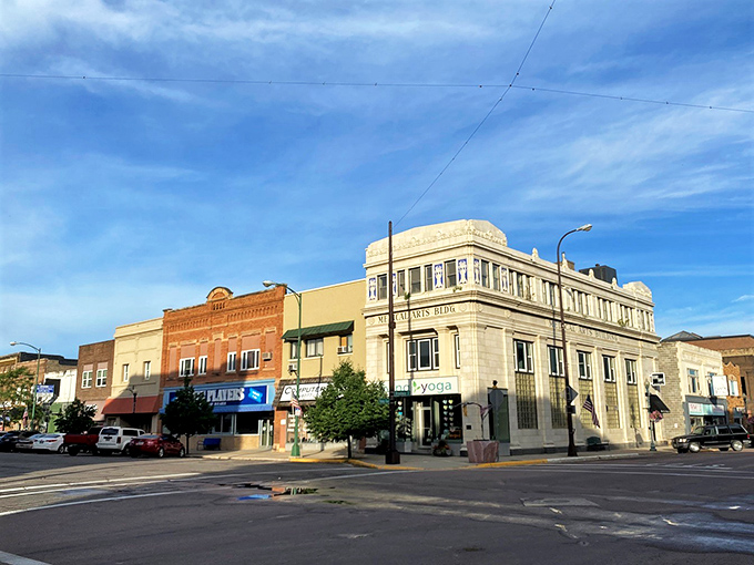 Downtown Watertown basks in golden hour light, where historic brick buildings stand proudly against a backdrop of South Dakota's endless sky.