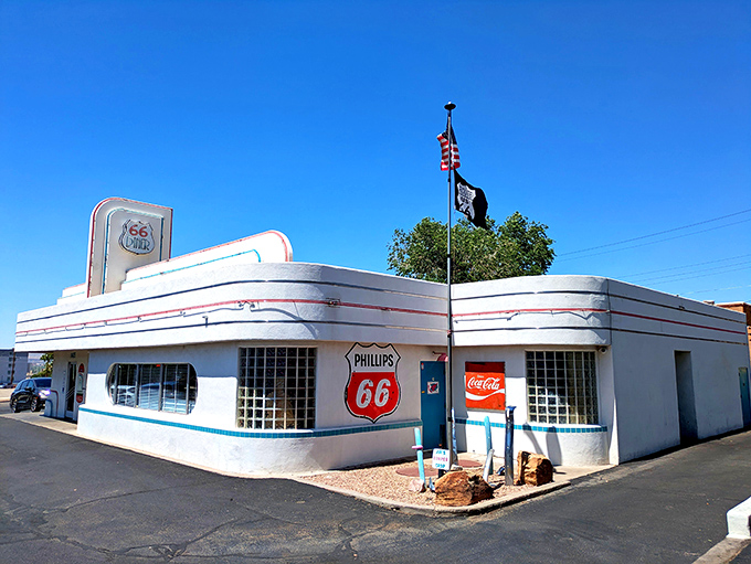 The gleaming white exterior of 66 Diner stands like a time capsule on Route 66, its streamlined curves and vintage signage promising a journey back to simpler times.