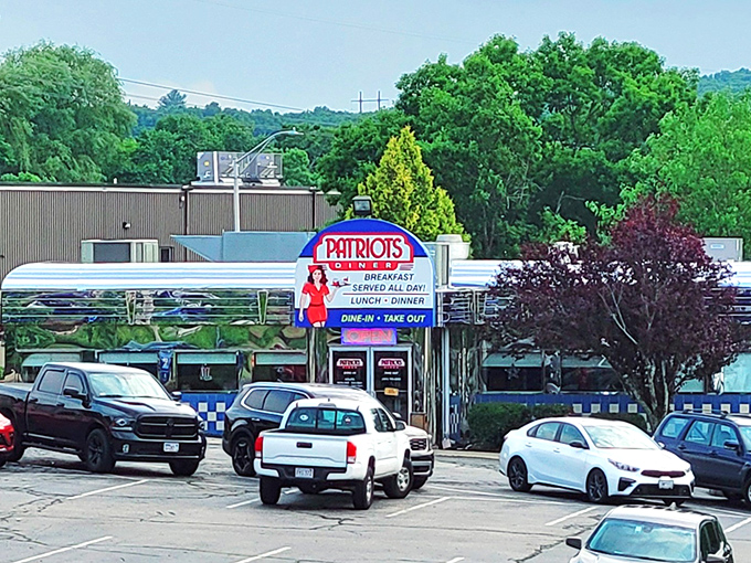 The iconic blue and white checkered exterior of Patriots Diner stands like a time machine to the golden age of American breakfast. That retro sign promises everything your morning needs.