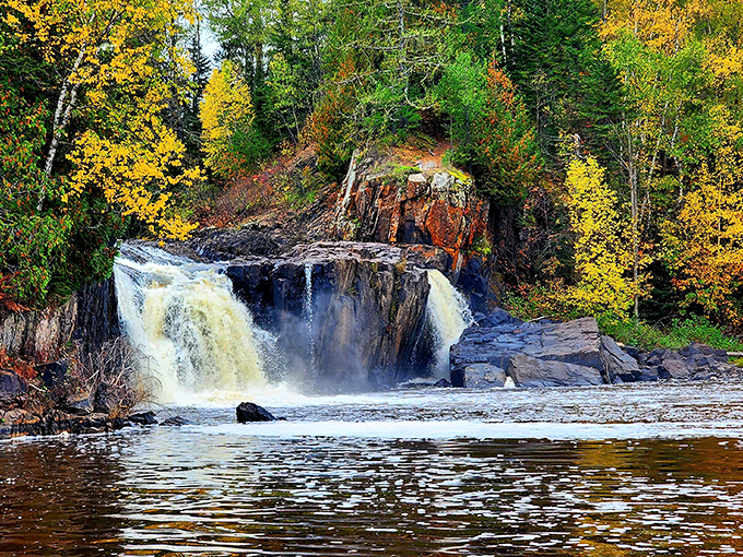 Nature's autumn palette on full display, framing the falls like Mother Nature's own masterpiece.