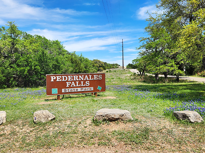 Where Texas shows off its true colors &ndash; a roadside sign that promises adventure while bluebonnets stand guard like tiny floral ambassadors of the Hill Country.