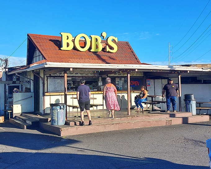 The iconic yellow "BOB'S" sign has been a beacon for hungry locals since the disco era. No fancy architecture needed when the food speaks this loudly.