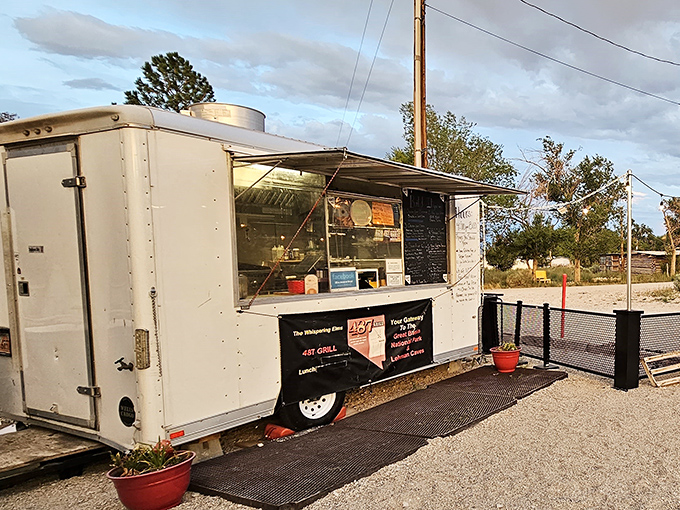 The humble white food trailer of 487Grill stands like a culinary lighthouse in Baker, beckoning hungry travelers with promises of burger perfection.