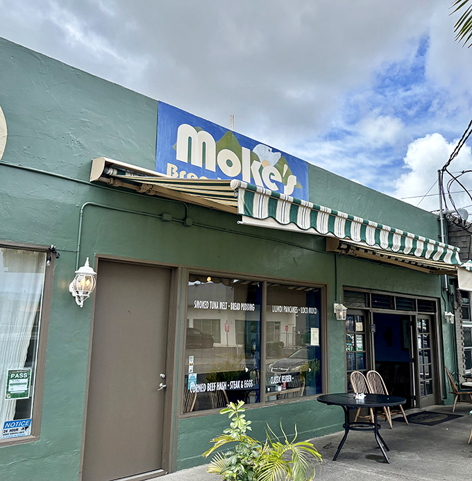 The unassuming turquoise facade of Moke's hides breakfast treasures within, like a culinary speakeasy that deals in pancakes instead of prohibition hooch.