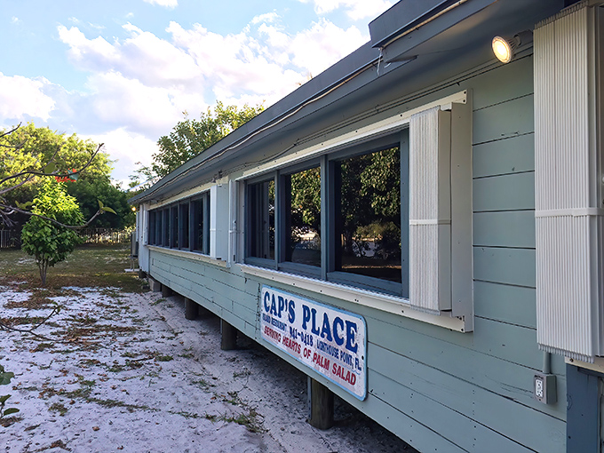 The unassuming exterior of Cap's Place belies the culinary treasures within. Like finding a pirate's chest disguised as a tackle box.