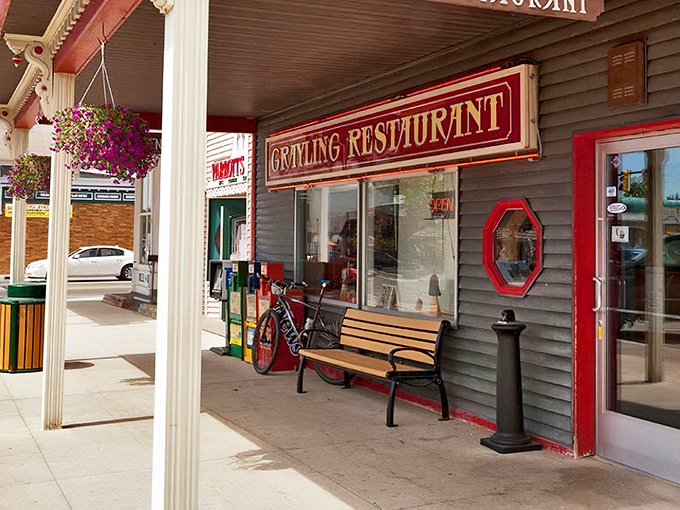 The iconic red sign beckons like an old friend – Grayling Restaurant's unassuming exterior hides breakfast magic that locals have treasured for generations.