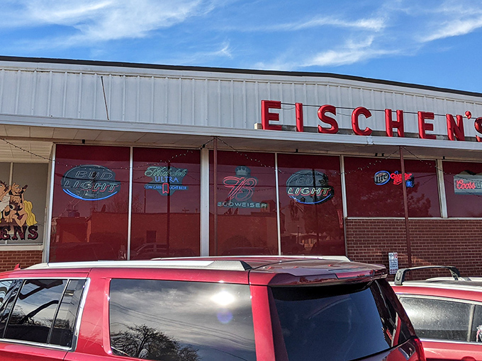 The unassuming exterior of Eischen's Bar stands like a culinary lighthouse in Okarche, beckoning hungry travelers with its iconic red signage.
