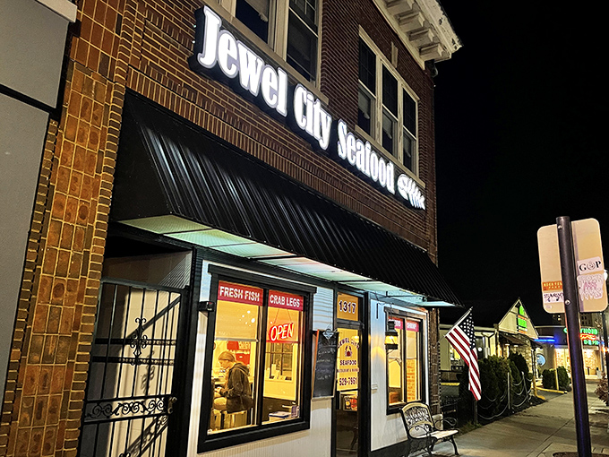 The glowing sign of Jewel City Seafood beckons like a lighthouse for hungry souls wandering through downtown Huntington after dark.