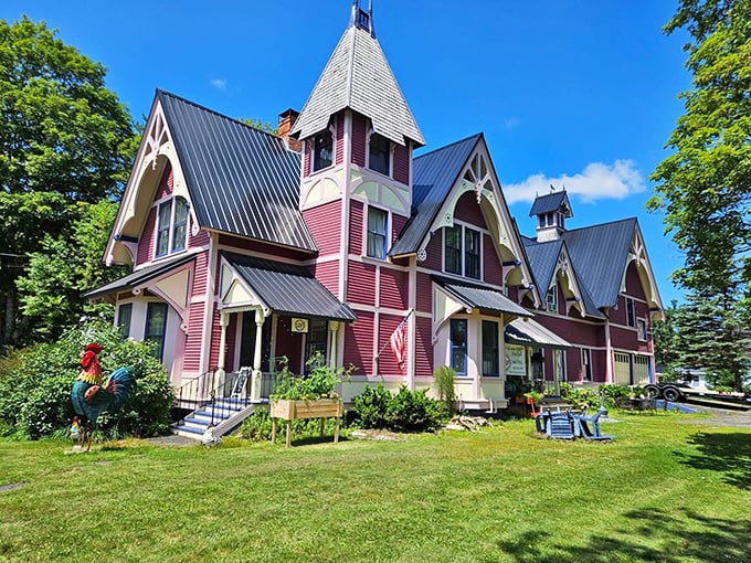 The pink Victorian mansion stands like a fairy tale come to life, its distinctive turrets and gables creating an architectural masterpiece against the Maine sky.