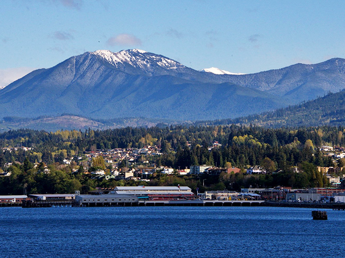 The Olympic Mountains stand sentinel behind Port Angeles, their snow-capped peaks a dramatic backdrop to this working waterfront town.
