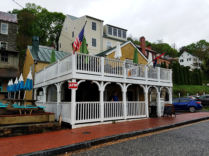 Stars, stripes, and welcoming porches&mdash;this riverside establishment embodies small-town hospitality with its classic white railings and American charm.