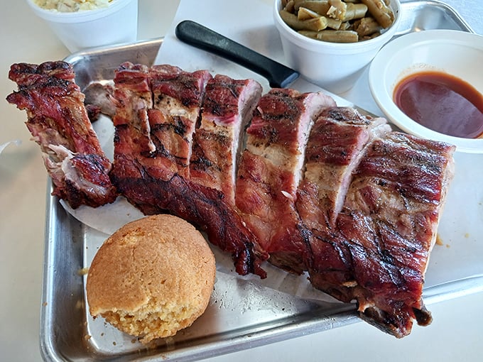 Ribs with that perfect pink smoke ring and a cornbread muffin standing by. This isn't food&mdash;it's edible architecture designed for pleasure.