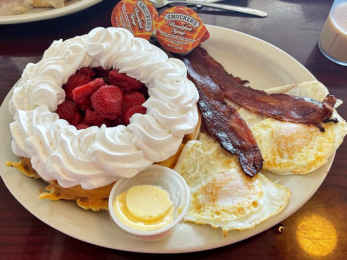 A Belgian waffle crowned with whipped cream and fresh berries proves that even classic diners know how to do a little fancy.