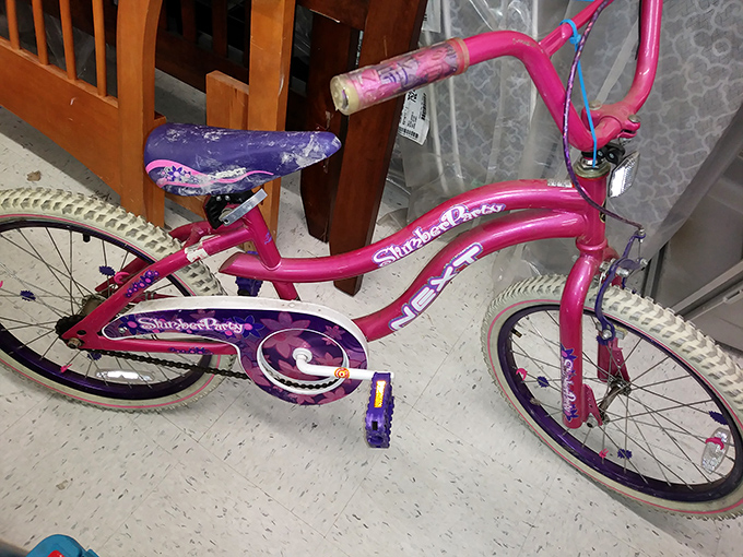 This pink bicycle screams childhood joy, ready to create new memories after outgrowing its previous young owner's adventures.