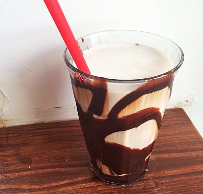 Chocolate milk elevated to grown-up status—swirls of rich chocolate dancing with creamy milk in a glass that brings back childhood joy with adult appreciation.