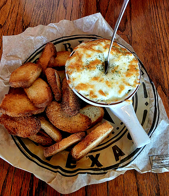 This creamy dip with toasted bread is the culinary equivalent of finding the perfect hiding spot during a zombie apocalypse&mdash;pure comfort.