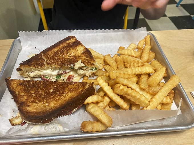 A grilled cheese sandwich that graduated with honors—crispy, gooey, and paired with perfectly crinkled fries for textural harmony.