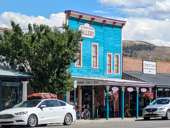 Gunnison Gallery's vibrant blue facade stands out like a sapphire among the historic buildings, offering cultural richness without the big-city price tag.
