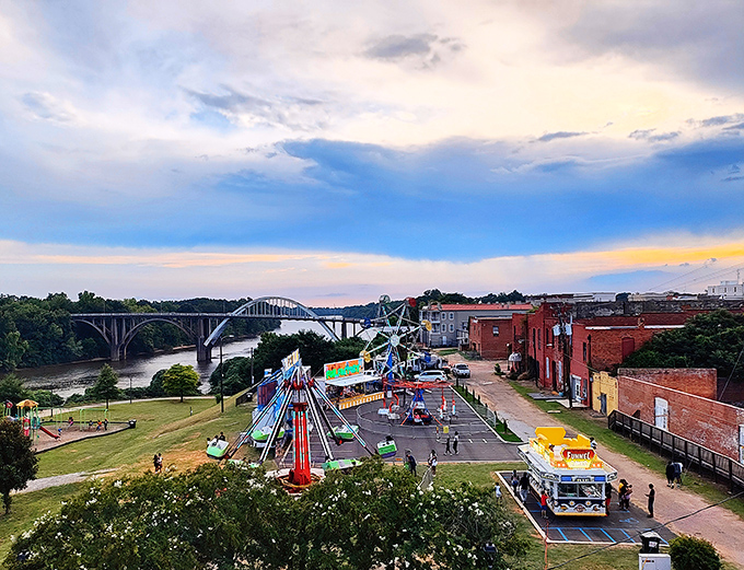 Carnival rides light up the riverfront against a dramatic sunset, proving that Selma knows how to throw a festival with the perfect backdrop.