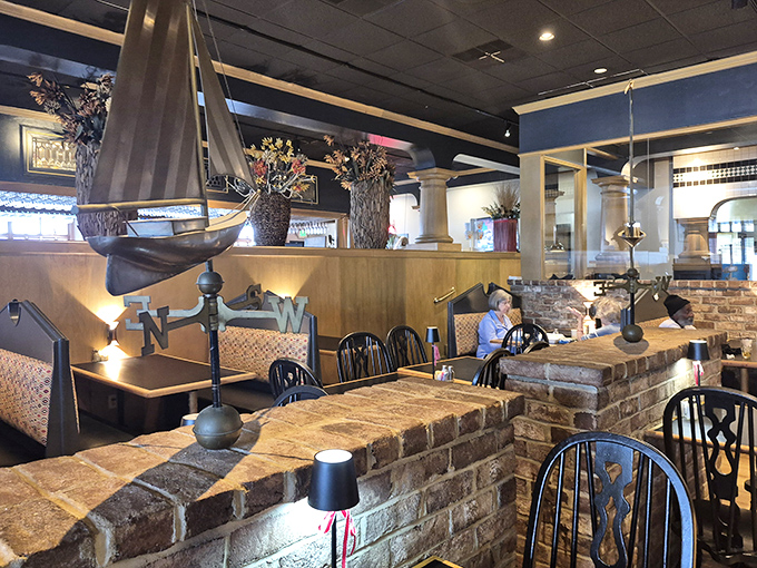 The dining room's thoughtful design creates intimate spaces within the larger restaurant, where model ships stand watch over satisfied diners.