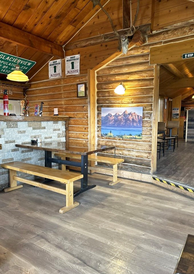 Rustic bench seating and log walls create the perfect backdrop for mountain-sized appetites. That skull isn't decoration&mdash;it's inspiration.