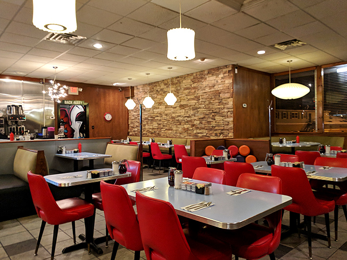 Mid-century modern meets comfort in Lucky's interior, where stone walls and starburst lights create a timeless dining atmosphere.