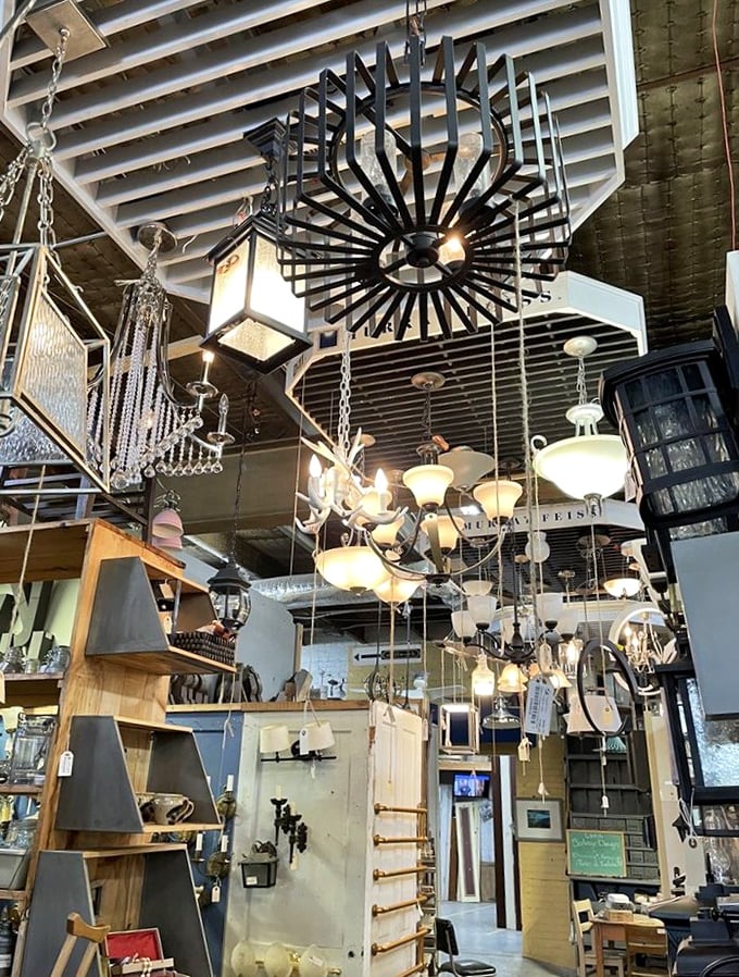 Look up! The ceiling becomes a gallery of illumination where chandeliers of every era dangle like stars in a design universe.