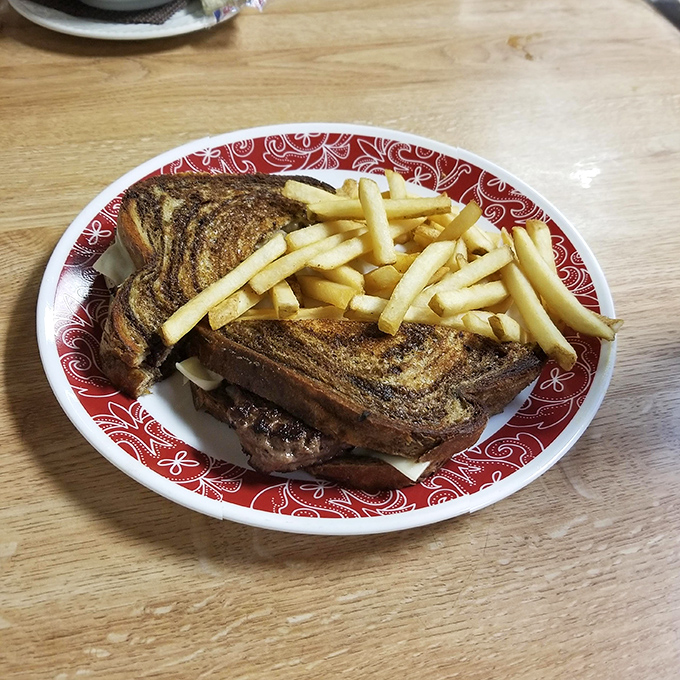 A grilled sandwich with fries that demonstrates the universal truth: melted cheese improves everything it touches, especially slow-smoked meat.