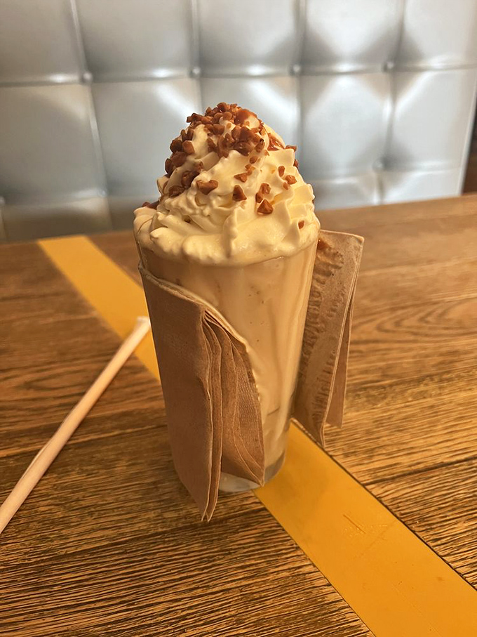 A milkshake that understands the importance of presentation. The praline topping isn't just garnish&mdash;it's the crown jewel of this creamy masterpiece.
