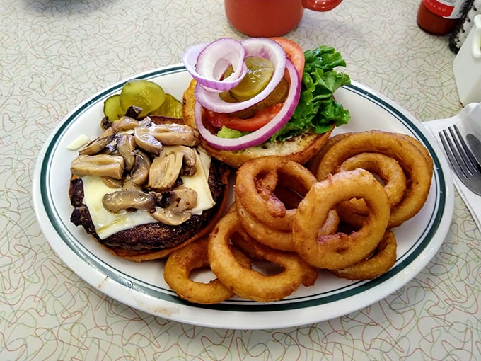 This burger isn't just topped with mushrooms and Swiss&mdash;it's crowned with them. Those onion rings are the royal court.