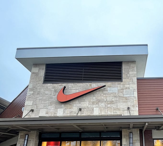 Nike's iconic swoosh beckons from above, silently promising that these discounted sneakers will definitely make you run faster.