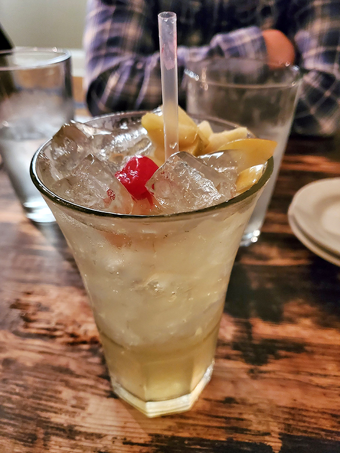 A cocktail that says "vacation mode activated" – crisp, refreshing, and garnished with enough fruit to count as a vitamin supplement.