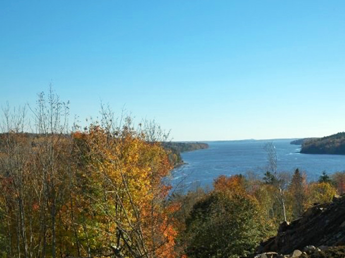 Fall foliage frames the river view like nature's own masterpiece &ndash; no wonder leaf-peepers get that glazed, happy look.