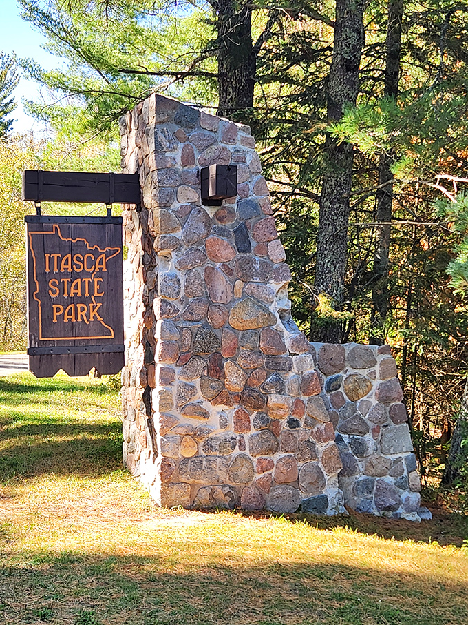 The stone entrance sign stands like a sentinel to paradise—less "Welcome to Jurassic Park" and more "Welcome to Your Best Day Ever."