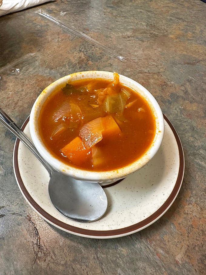 Vegetable soup that tastes like someone's grandmother made it – chunks of carrots and potatoes swimming in savory broth.