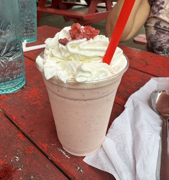 A strawberry milkshake topped with whipped cream and berries&mdash;the perfect cool companion to a hot Texas day and a spicy burger.